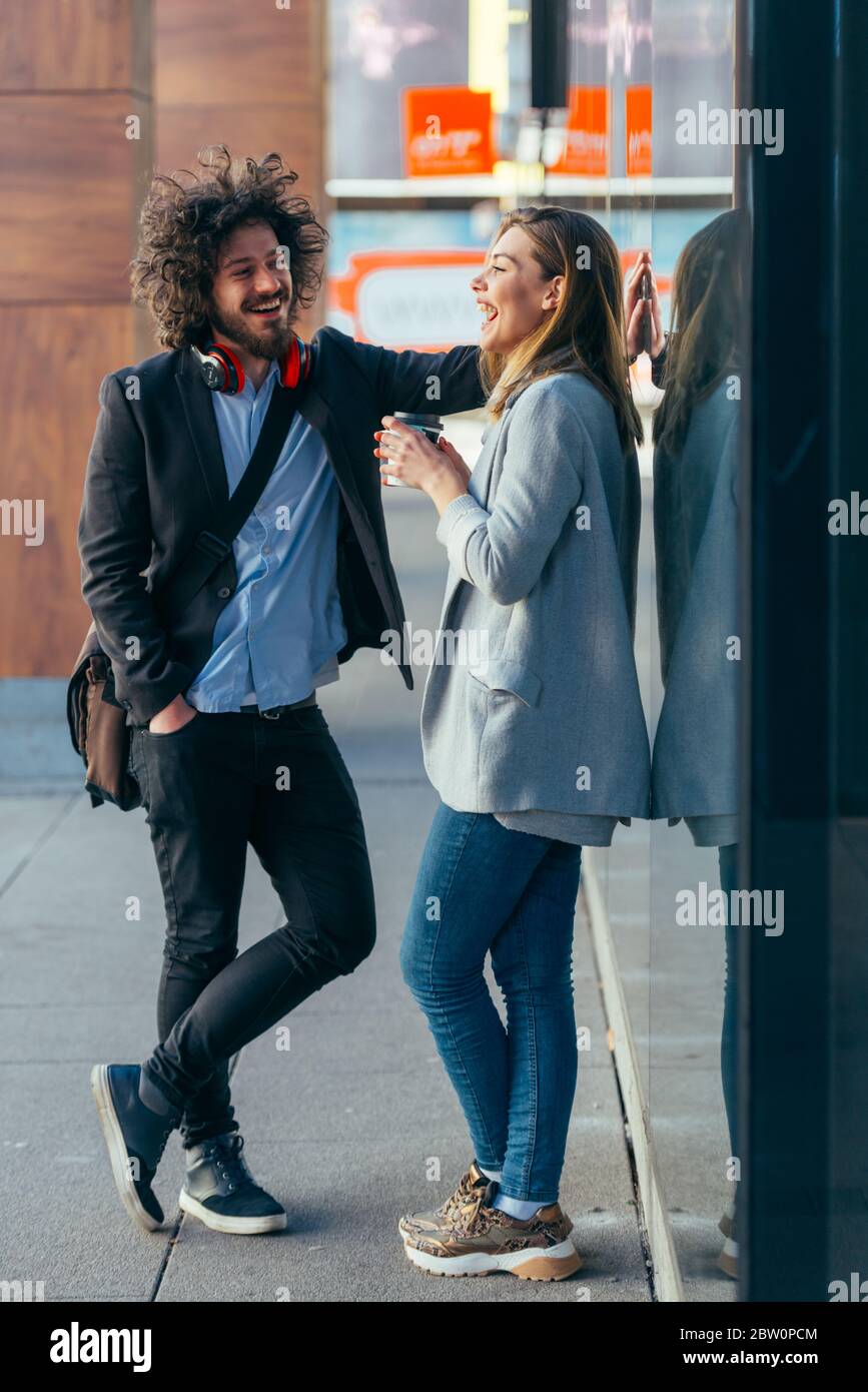 College student flirting with his female friend at university while ...