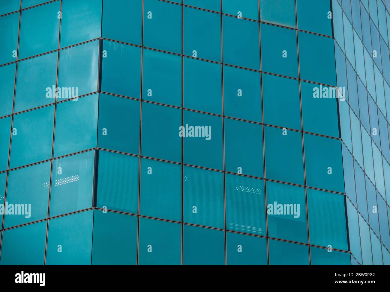 Modern skyscraper with a futuristic blue glass exterior Stock Photo - Alamy