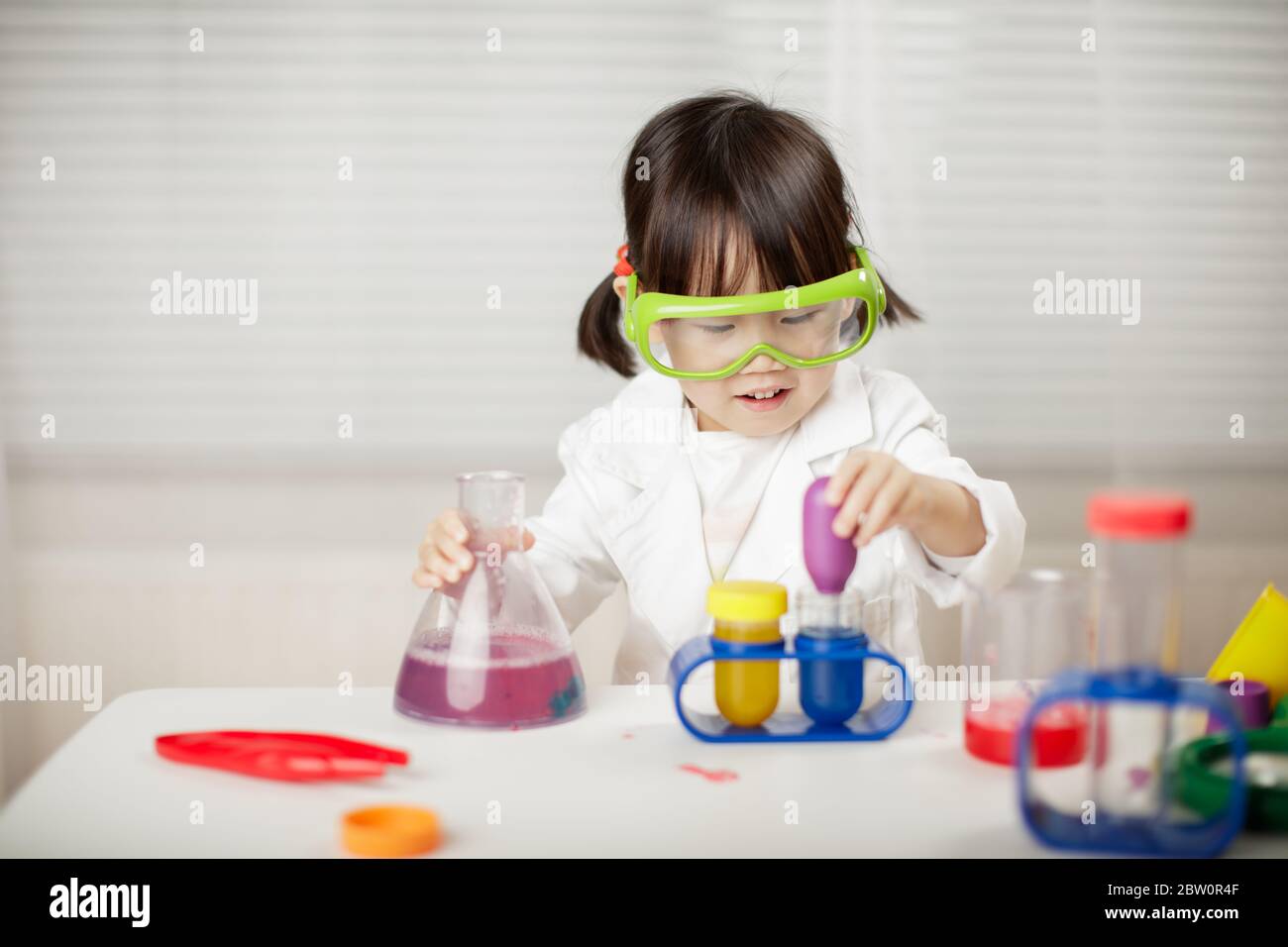 toddler girl pretend play scientist role for homeschooling Stock Photo ...