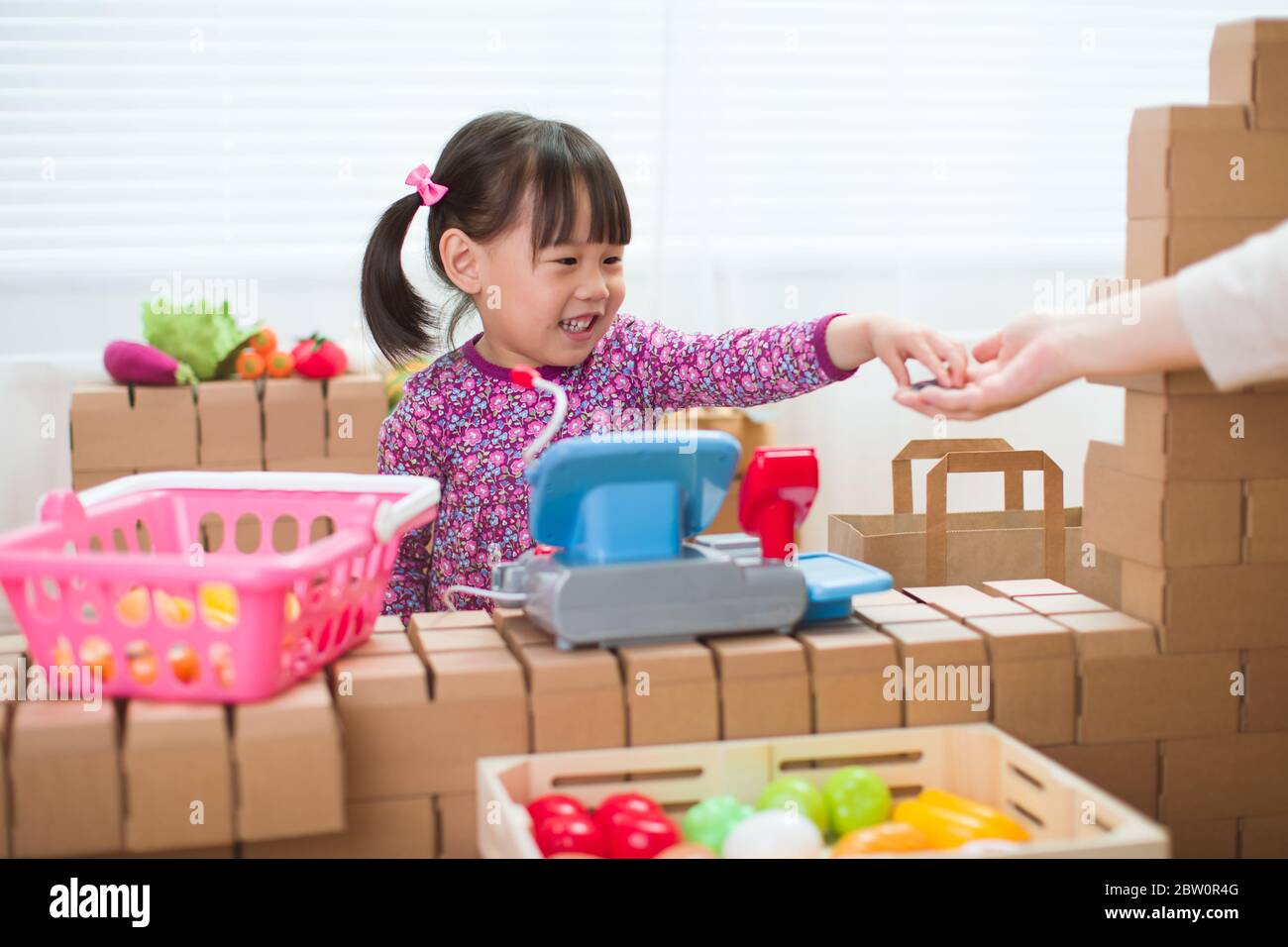 toddler girl pretend play sweet shop keeper at home Stock Photo - Alamy
