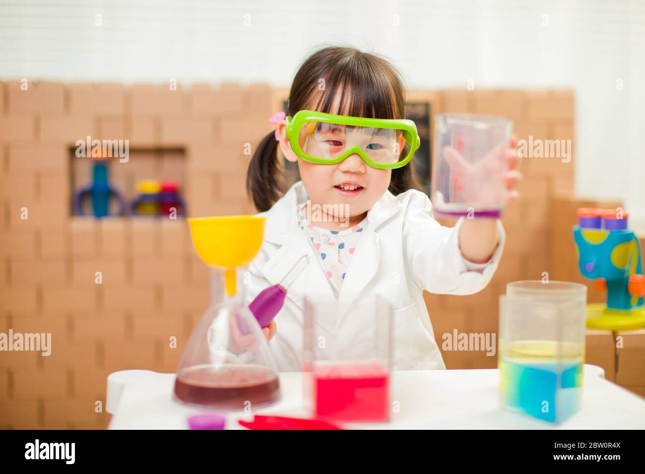 toddler girl pretend play scientist role for homeschooling Stock Photo ...