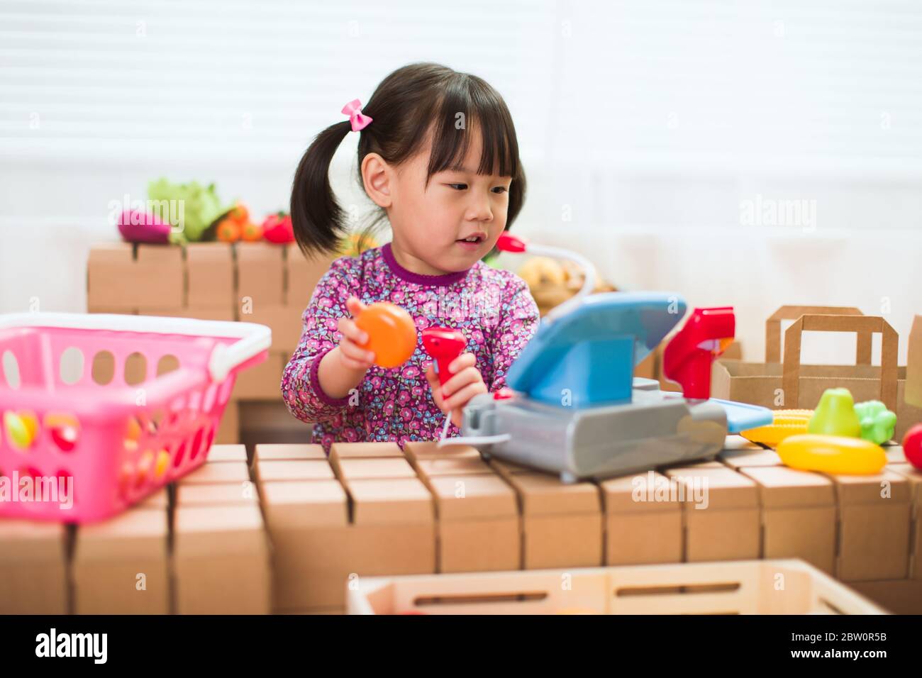 toddler girl pretend play sweet shop keeper at home Stock Photo - Alamy