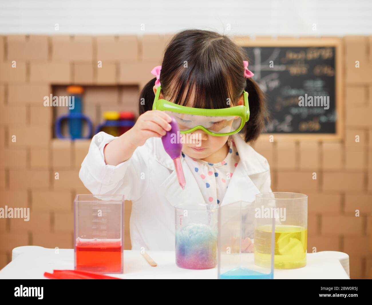 toddler girl pretend play scientist role for homeschooling Stock Photo ...