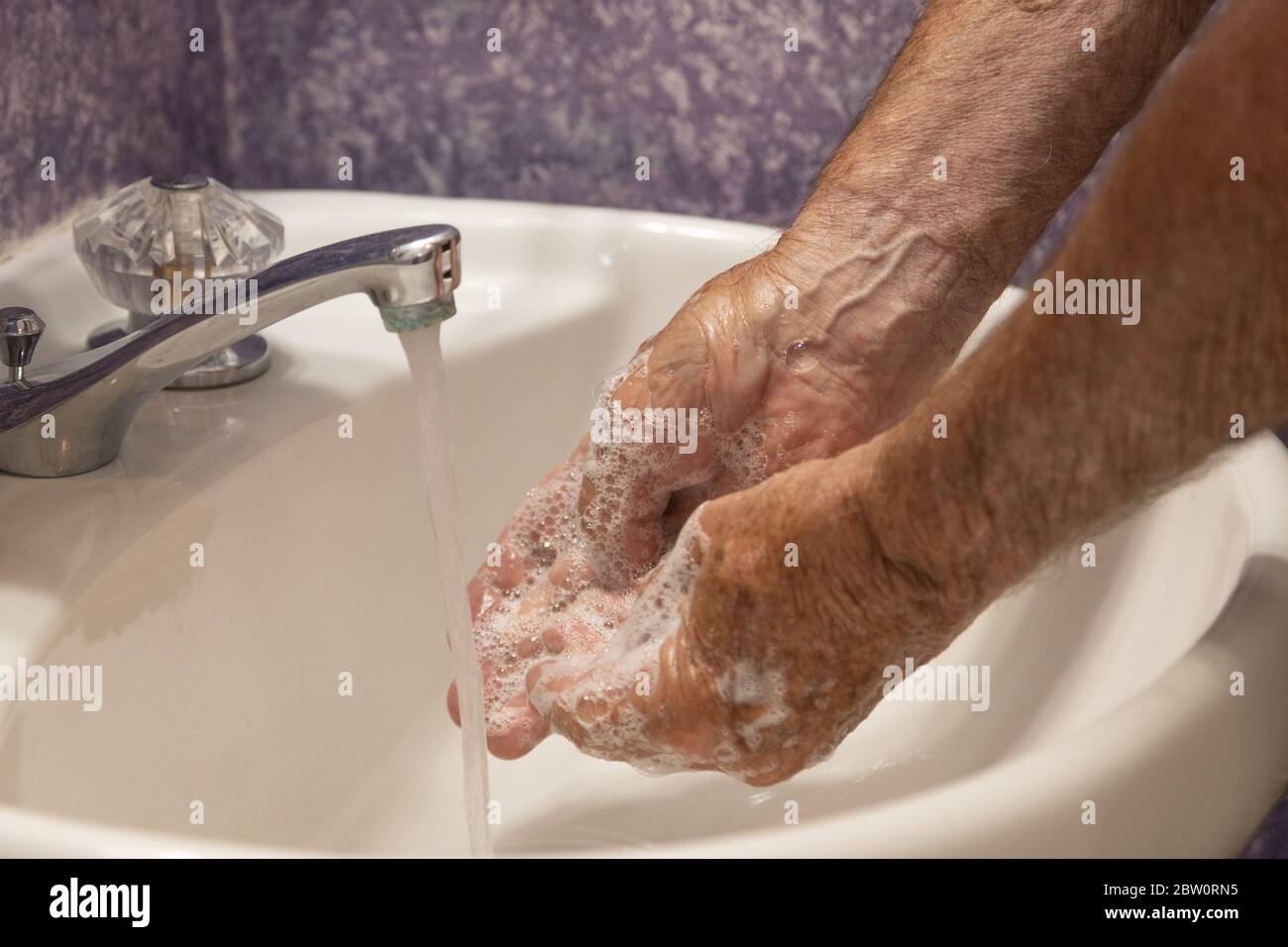 Old man washing hands water hi-res stock photography and images - Alamy
