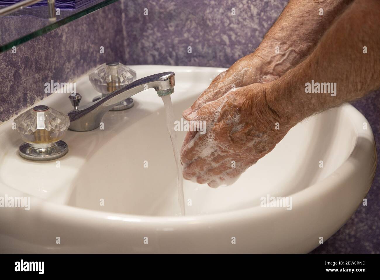 Old man washing hands water hi-res stock photography and images - Alamy
