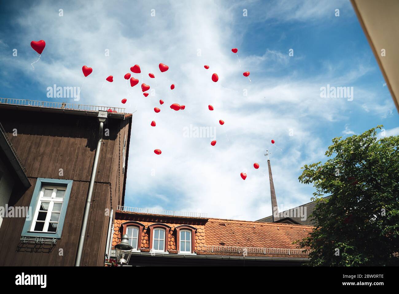 Romantic shot of red love heart balloons rising to sky. Group of ...