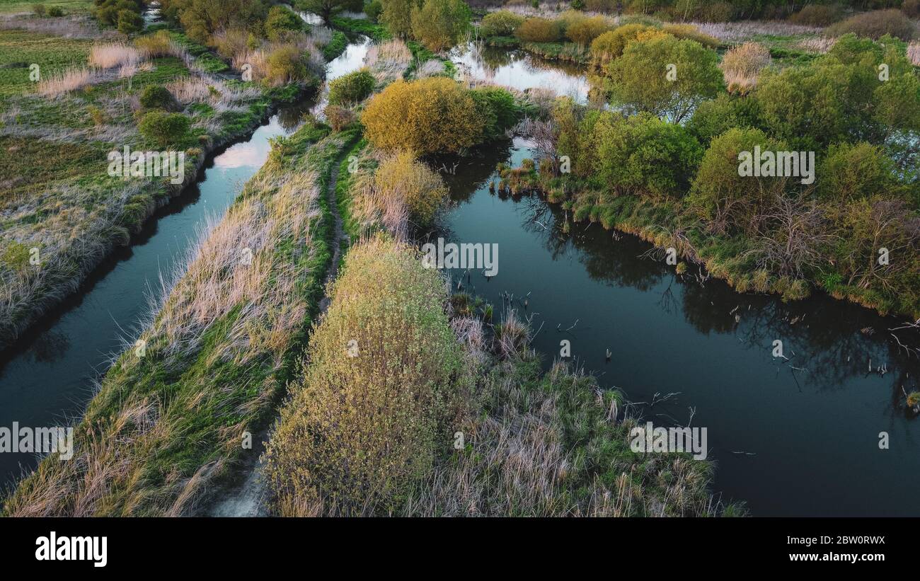 Beautiful aerial view on small rural rivers and forest trees from above ...