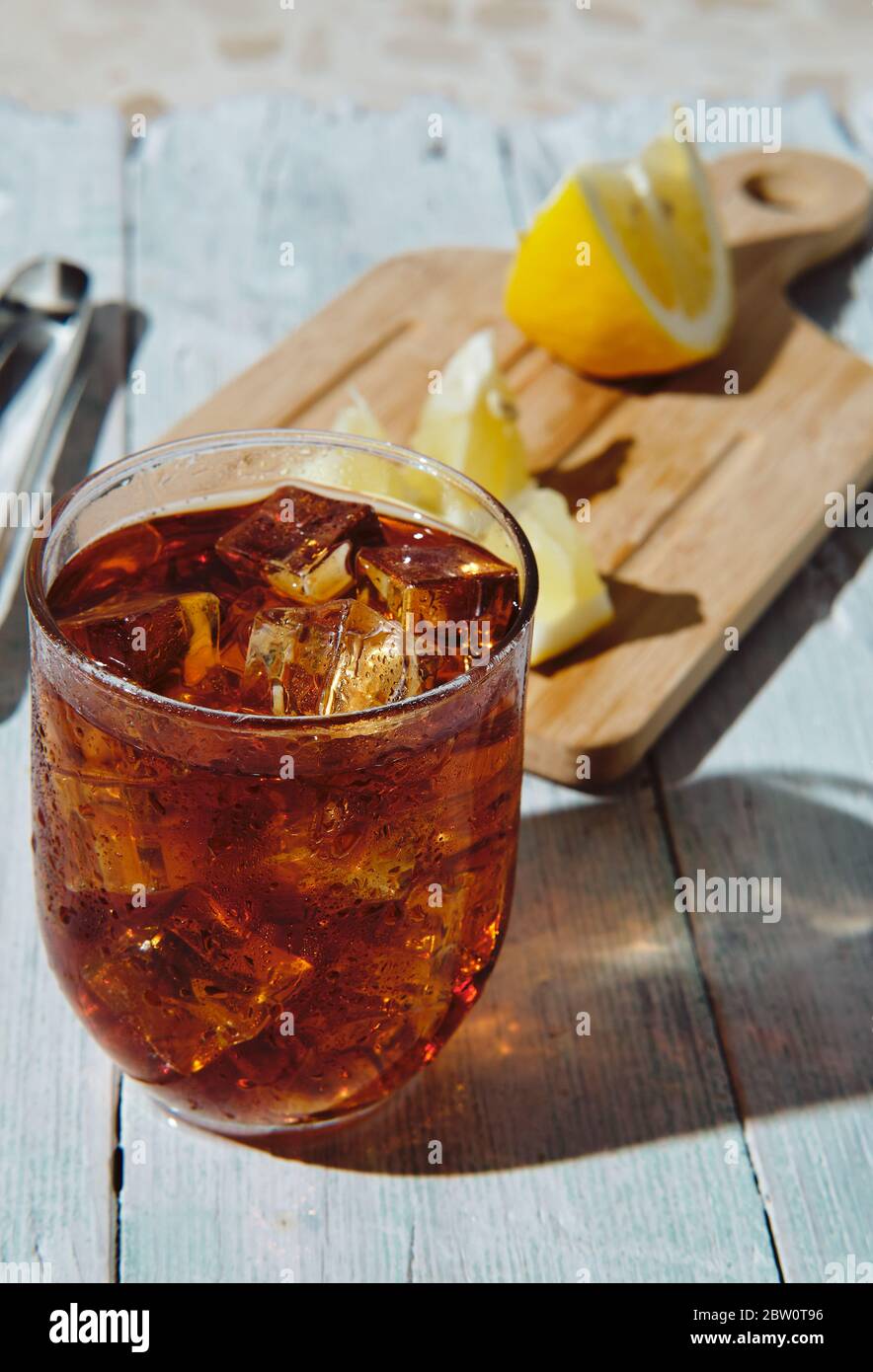 very cold cola on a white background with ice and lemon Stock Photo - Alamy