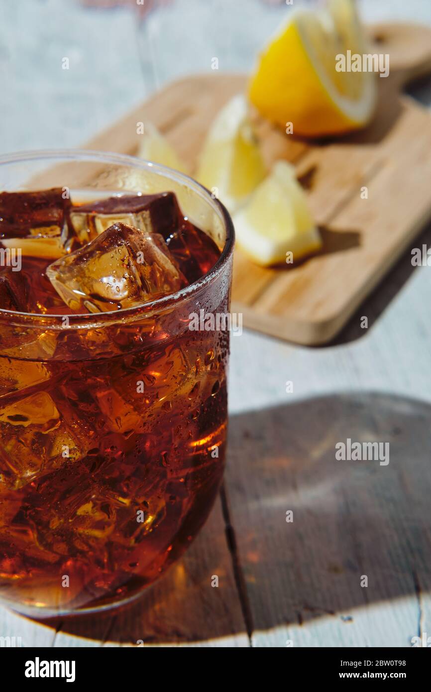 very cold cola on a white background with ice and lemon Stock Photo - Alamy