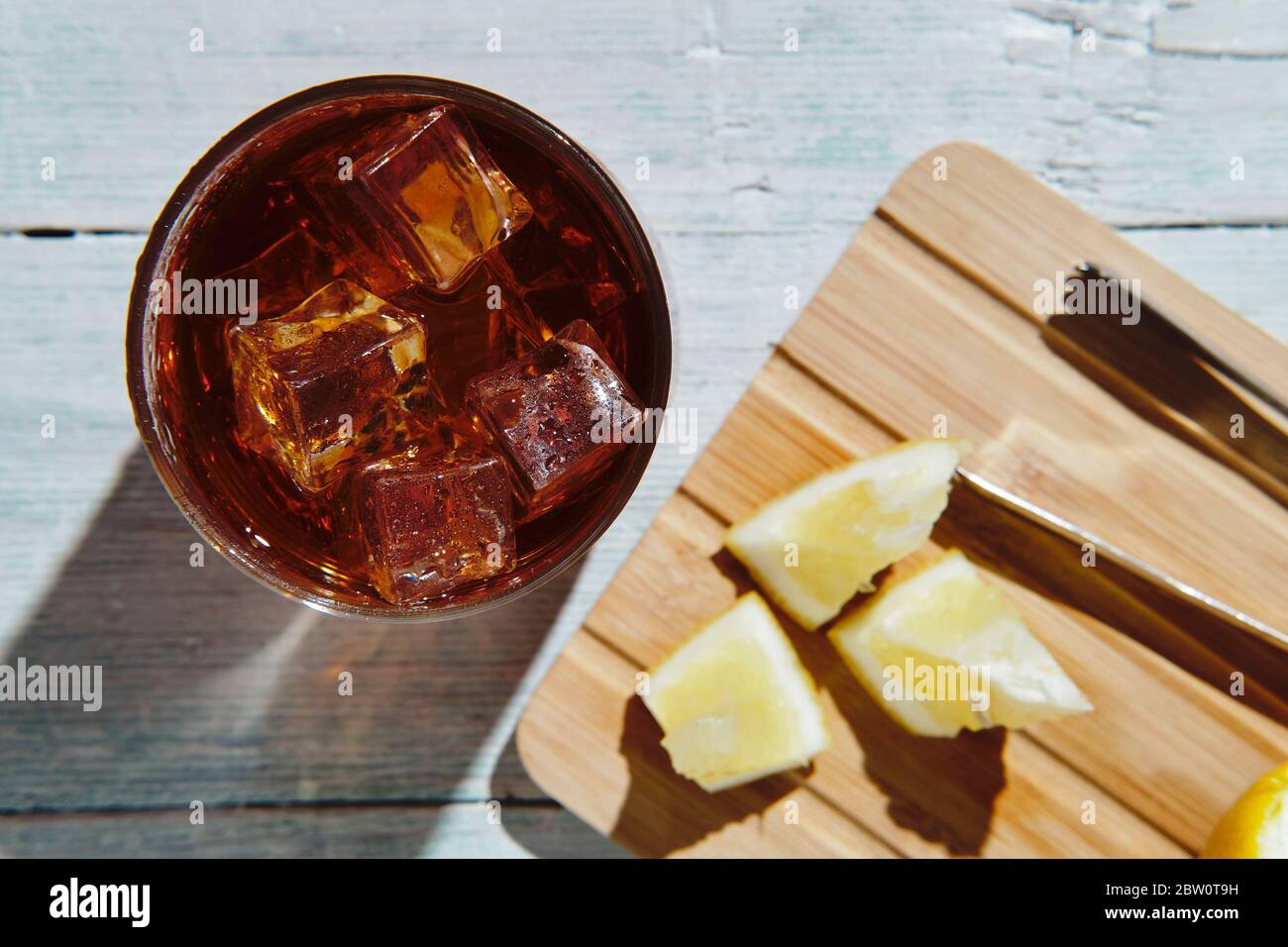very cold cola on a white background with ice and lemon Stock Photo - Alamy