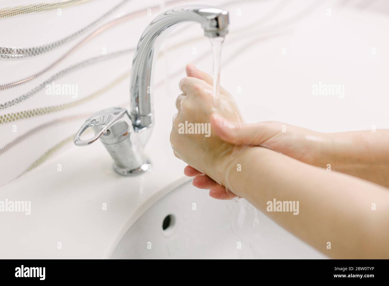Woman washes her hands by surgical hand washing method. She washes his ...