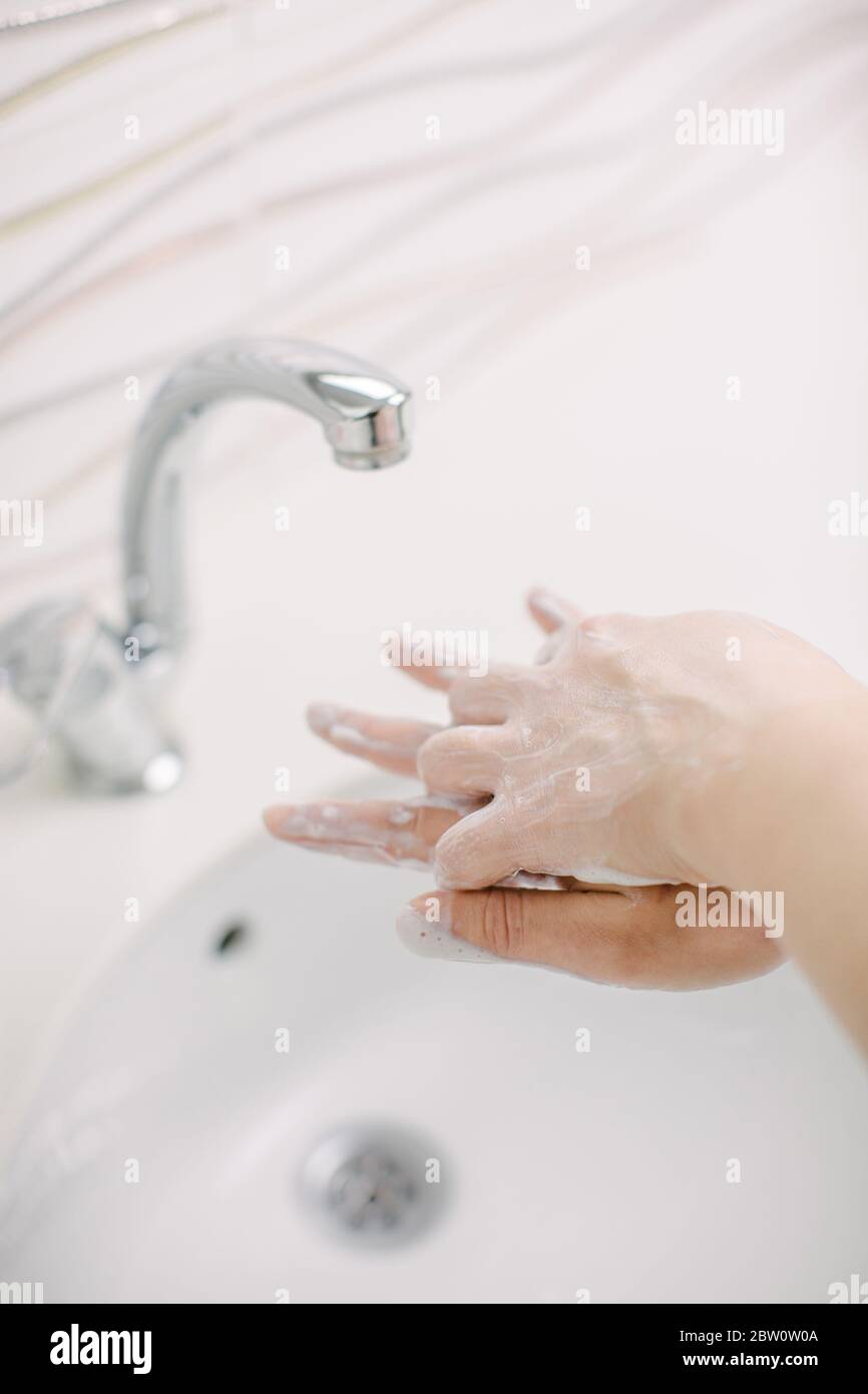 Woman washes her hands by surgical hand washing method. She washes his ...