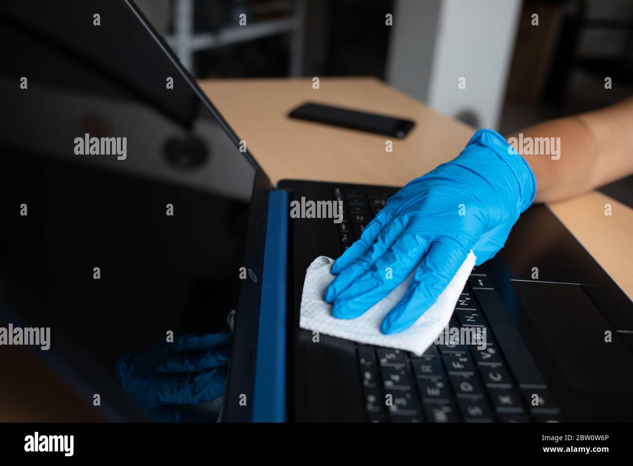 work from home safe, cleaning and disinfecting laptop computer with wet ...