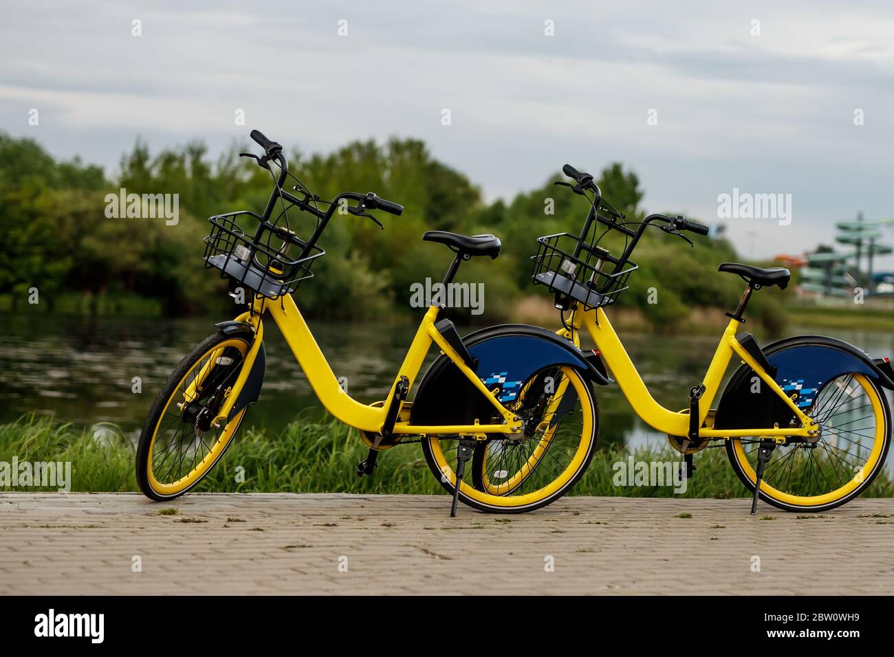 Two yellow city bikes by the lake Stock Photo - Alamy