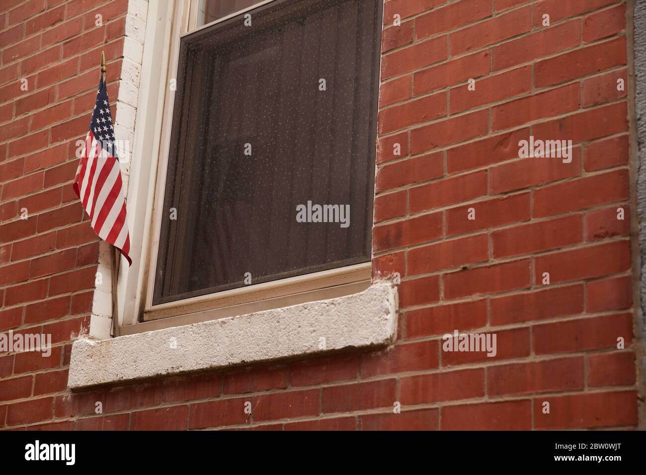 American flag on a window in Boston Stock Photo - Alamy