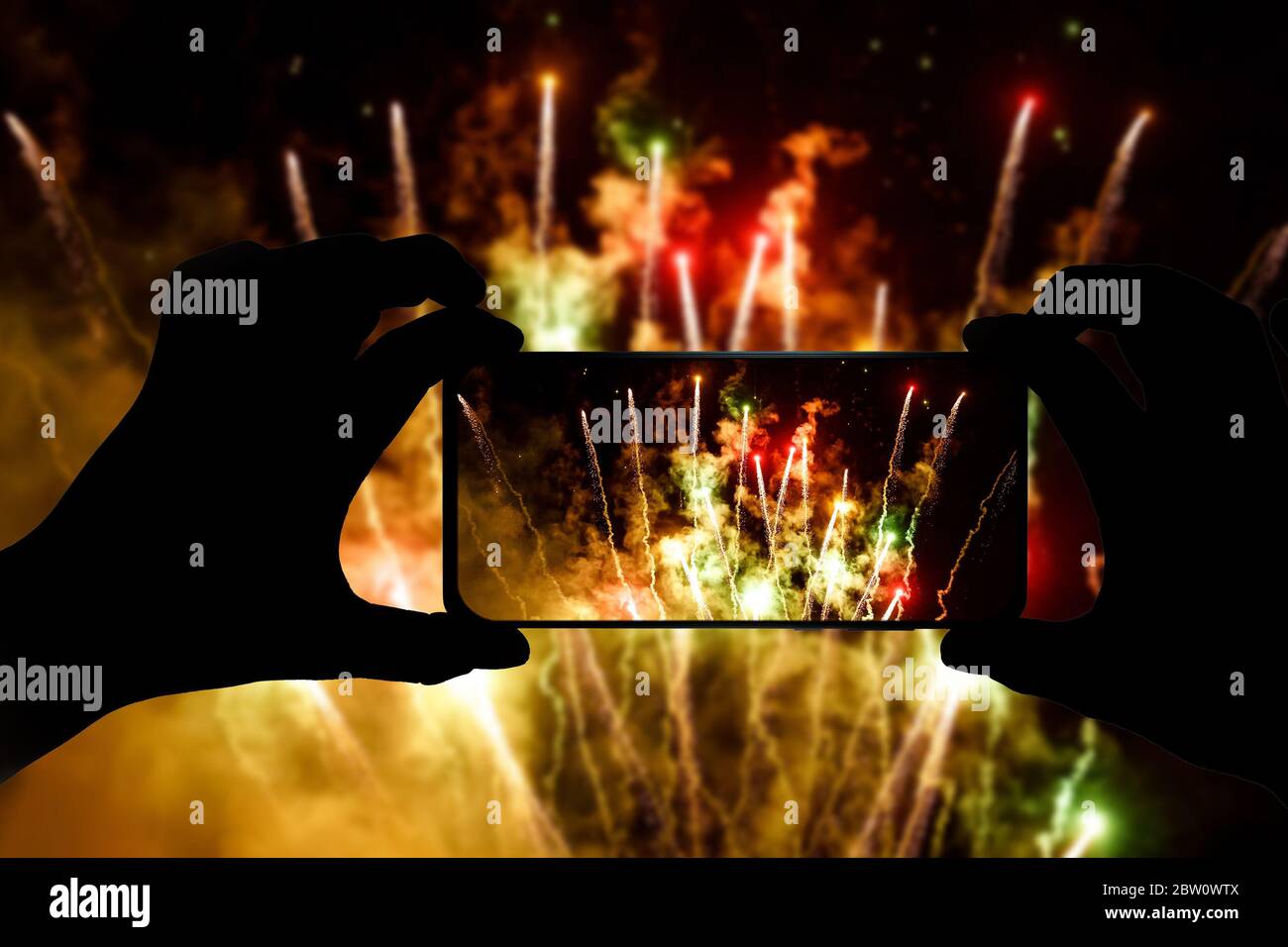 Taking the photo of fireworks via smartphone. Broadcast salute video to ...