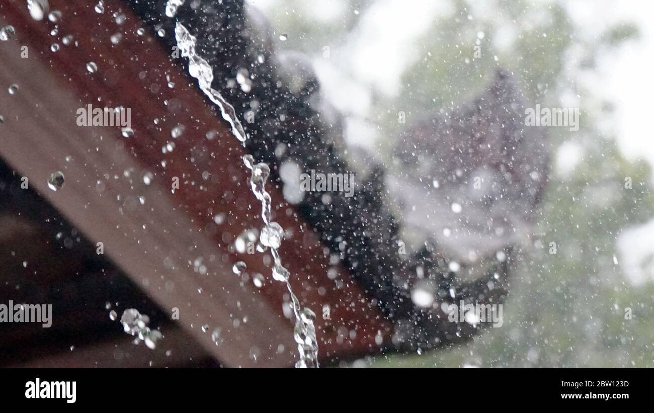 Raindrops falling from roof hi-res stock photography and images - Alamy
