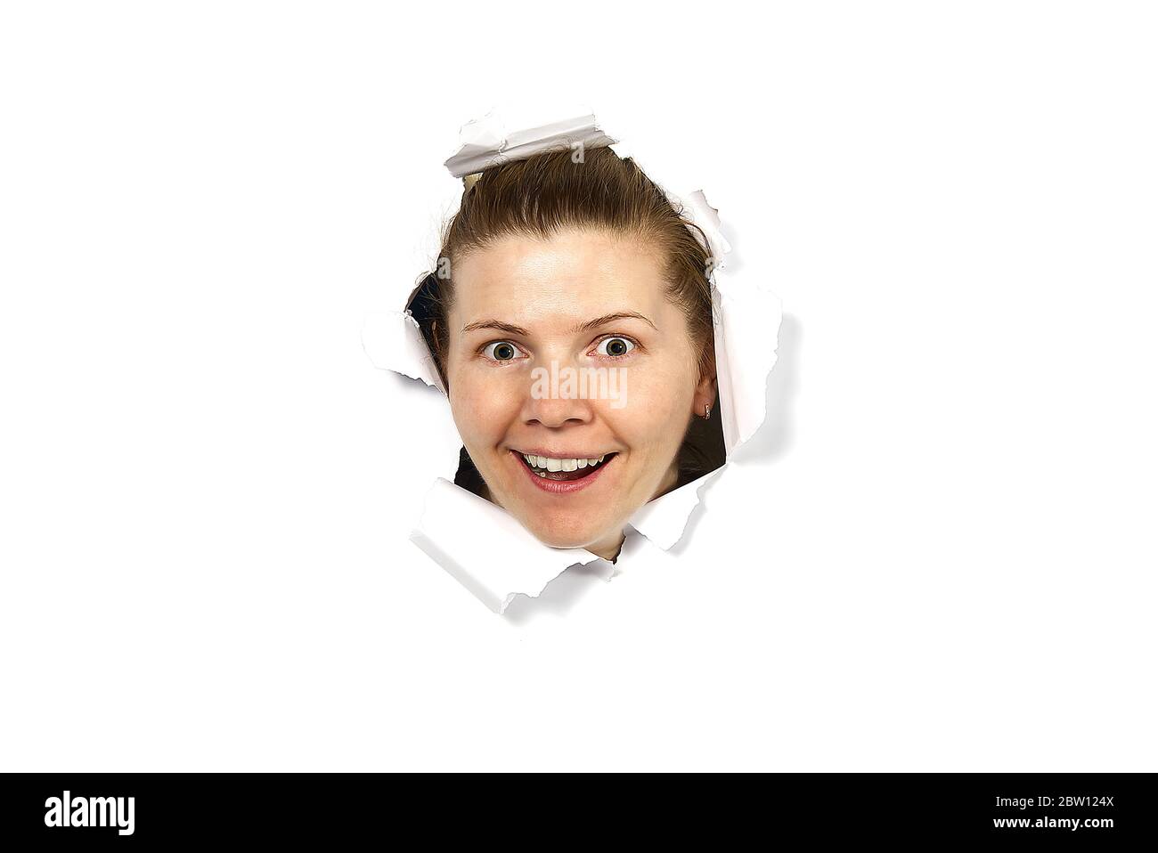 Young woman peeping through hole on paper. Female Eye looking through ...