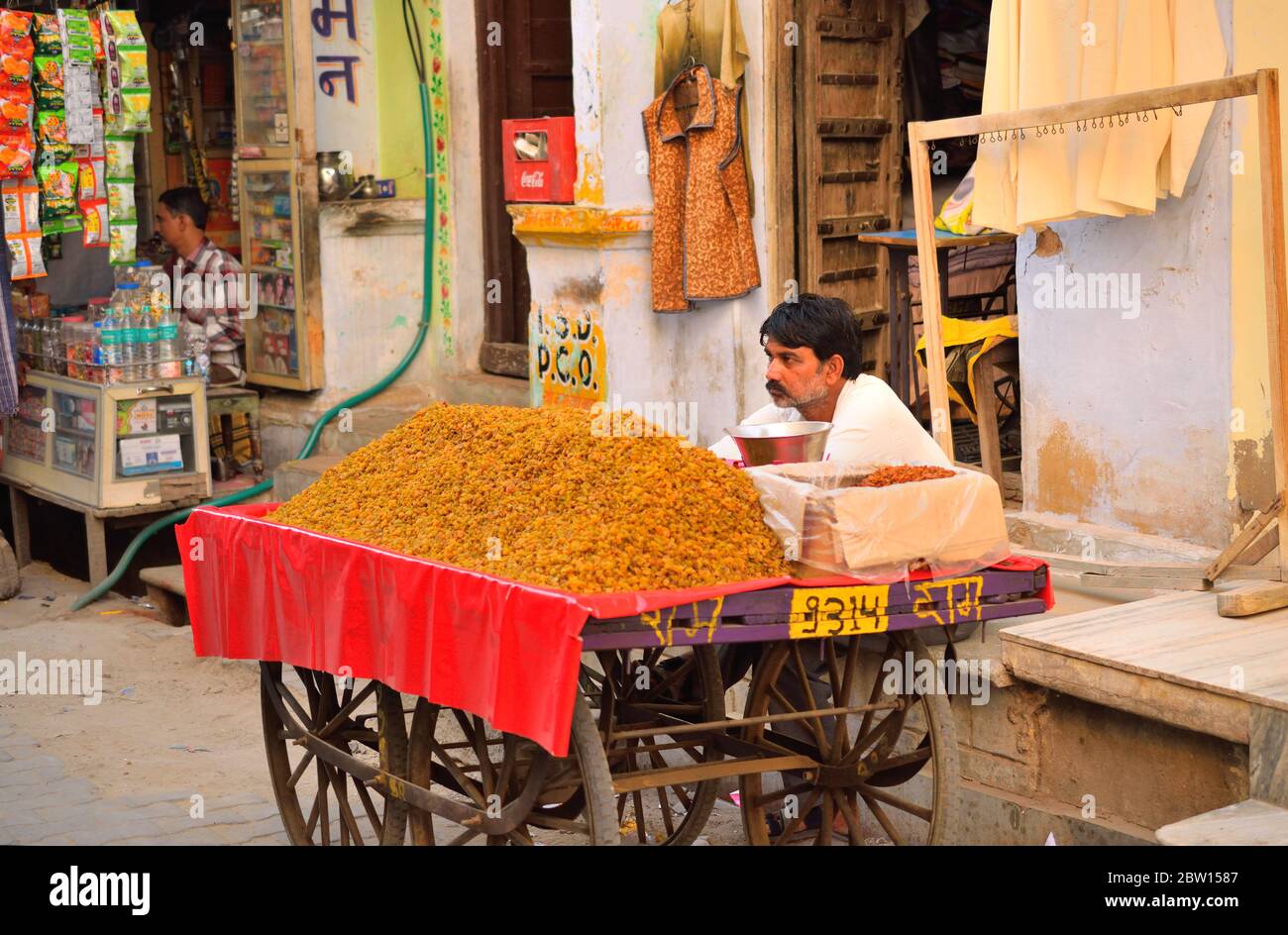 A man selling raisins by the street side Stock Photo - Alamy