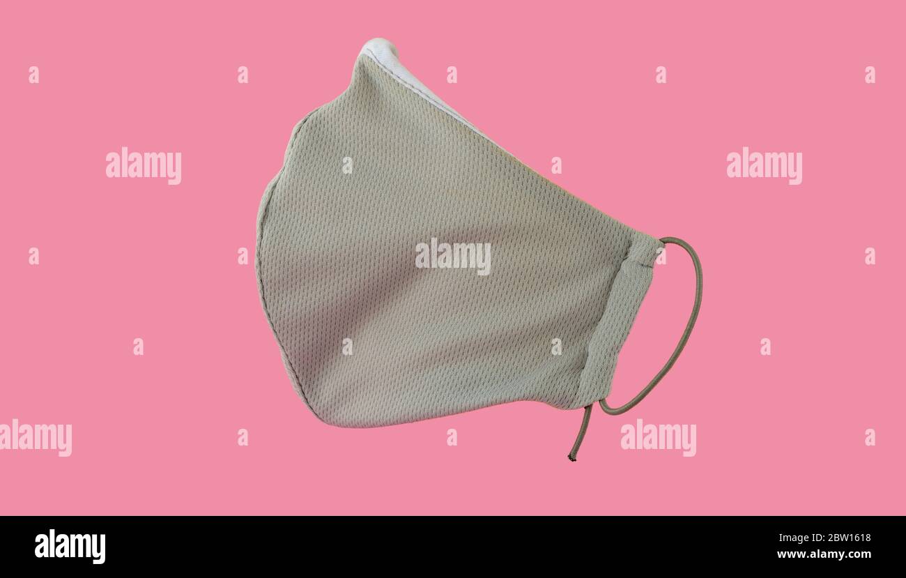 reusable medical mask on a pink background. side view. coronavirus ...