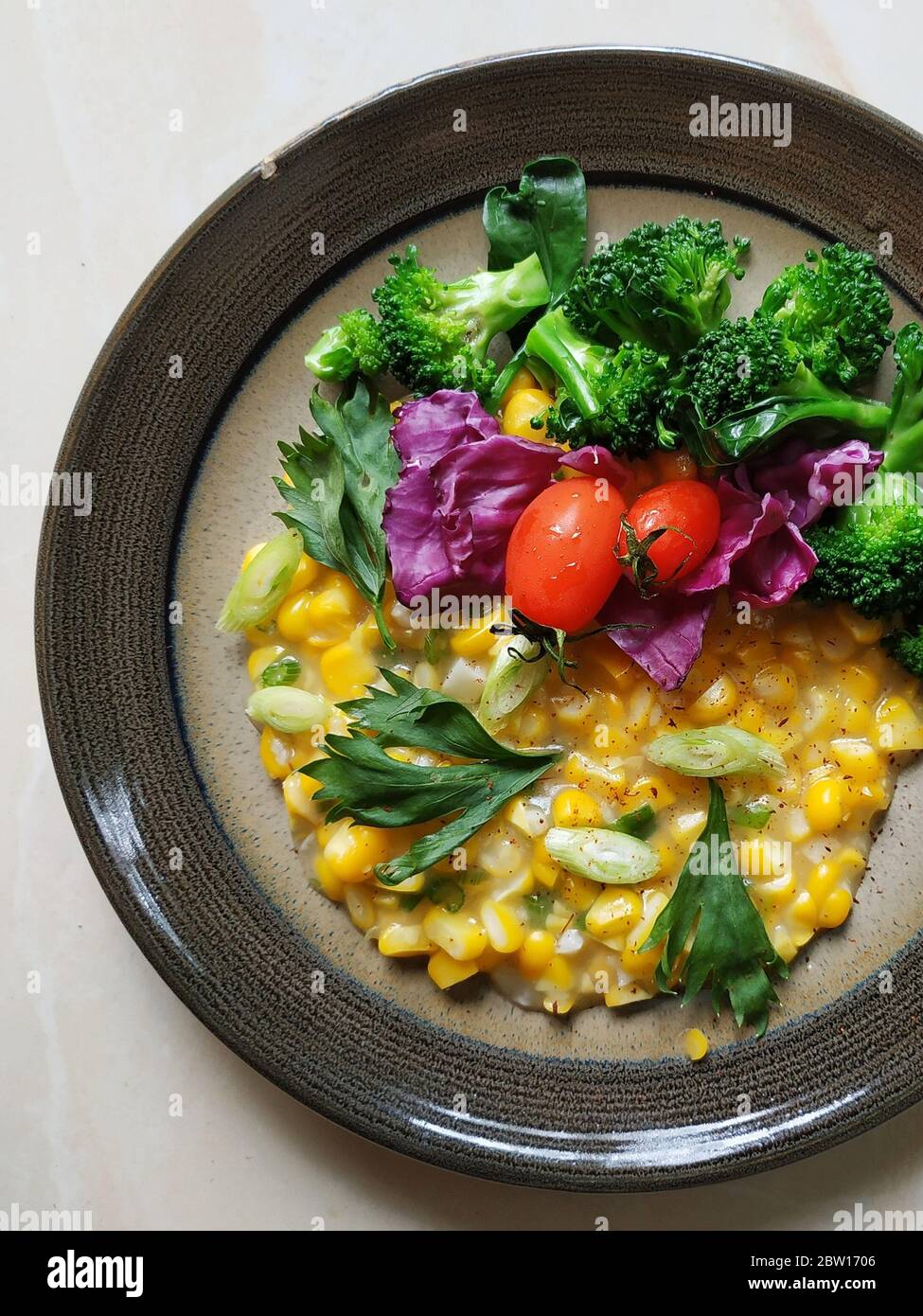 Indonesian cornmeal grits with broccoli, tomatoes, and sliced purple ...