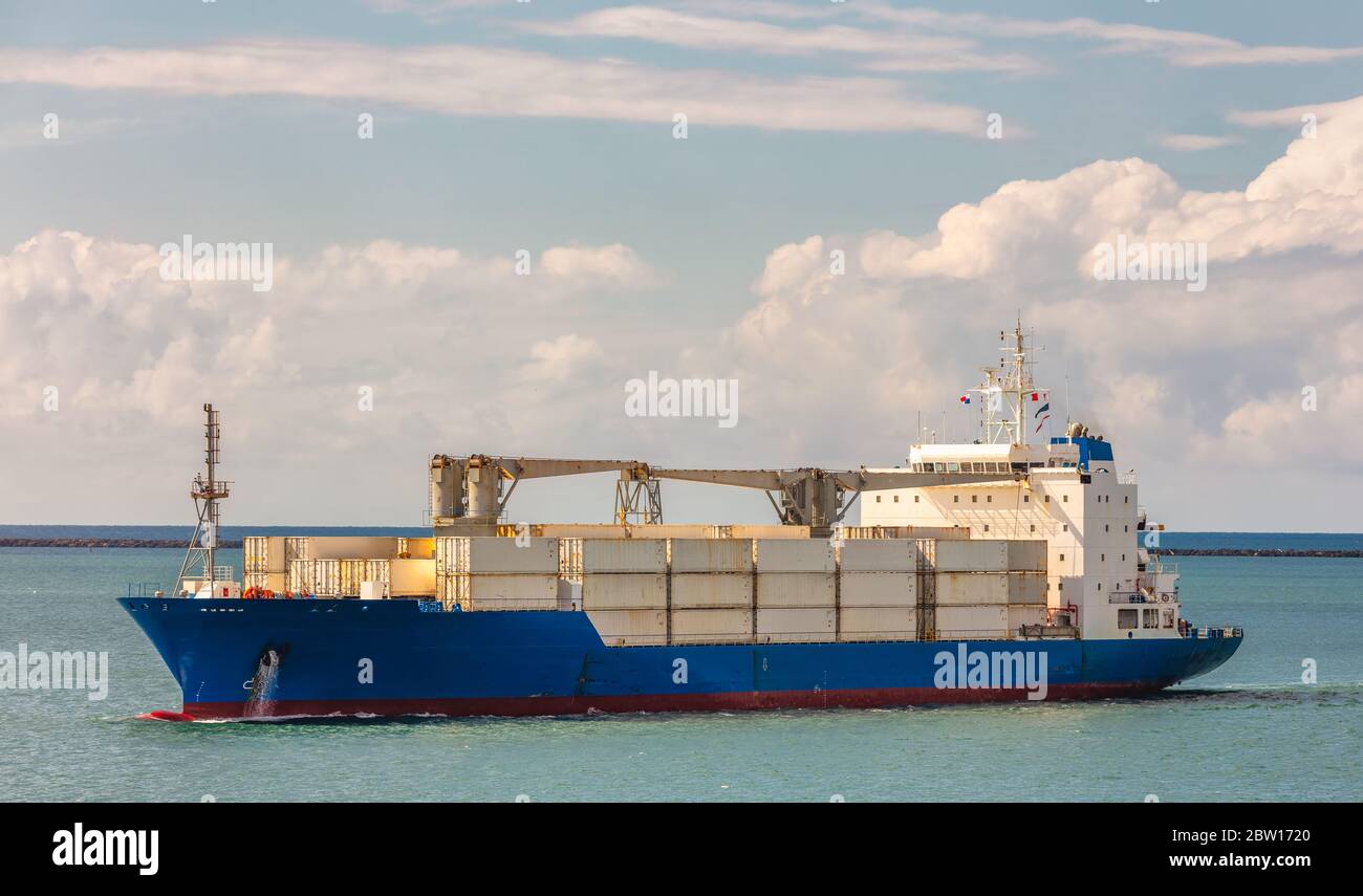 Cargo ship in Panama Canal. Various containers and cranes on deck ...