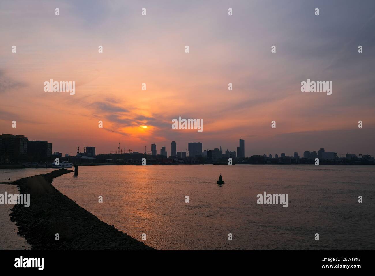City of Rotterdam Skyline with Erasmusbrug bridge at sundown in evening ...
