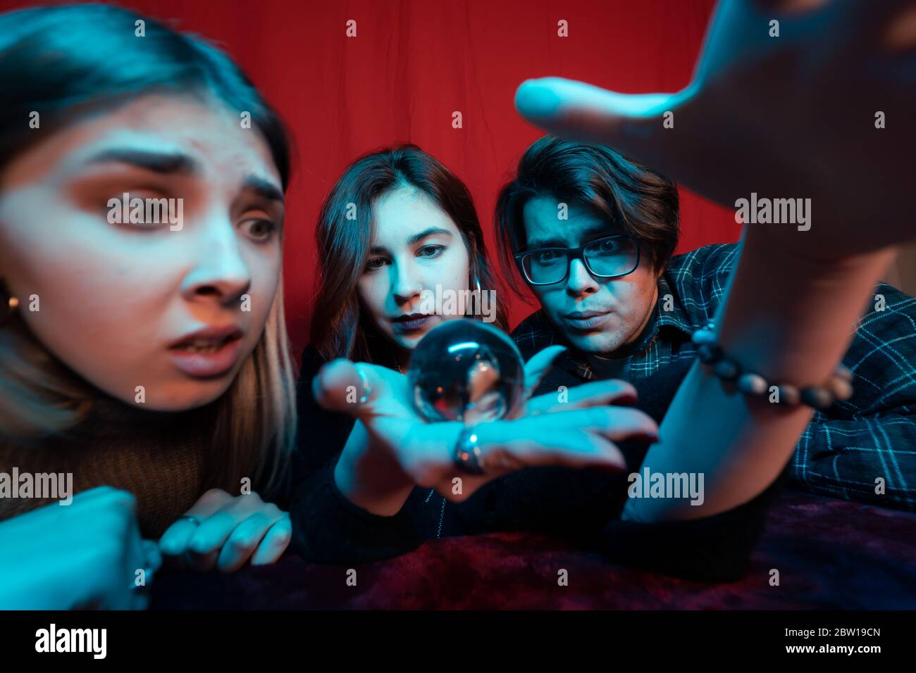 Group of people and woman fortune teller with crystal ball Stock Photo ...
