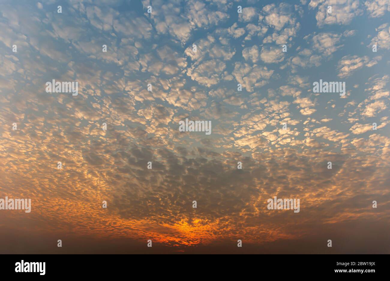 The sunset sky is beautiful in orange, the clouds spread into cubes ...