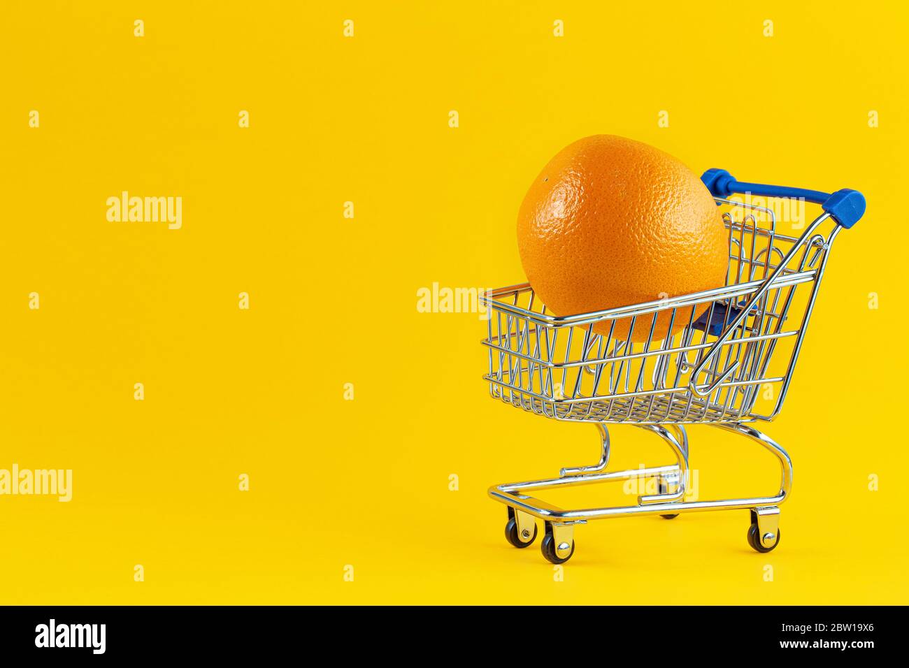 Shopping cart with with orange. Large bright oranges in the cart for ...
