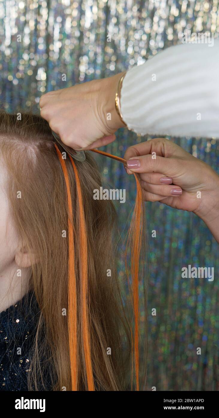 Capsule hair extensions in professional beauty salon. Process of hair ...