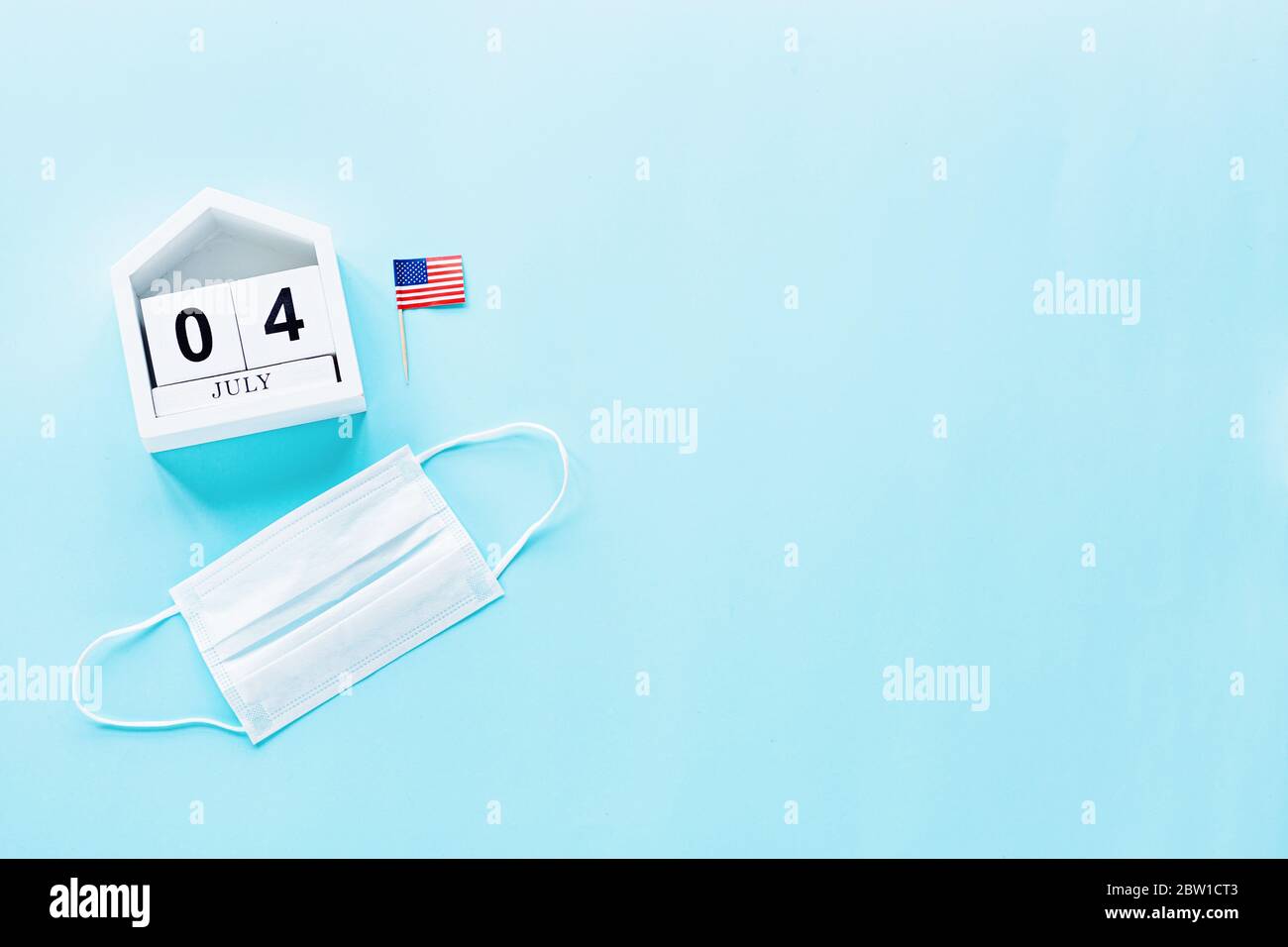 July 4th. USA flag and medical mask on blue background. Independence ...