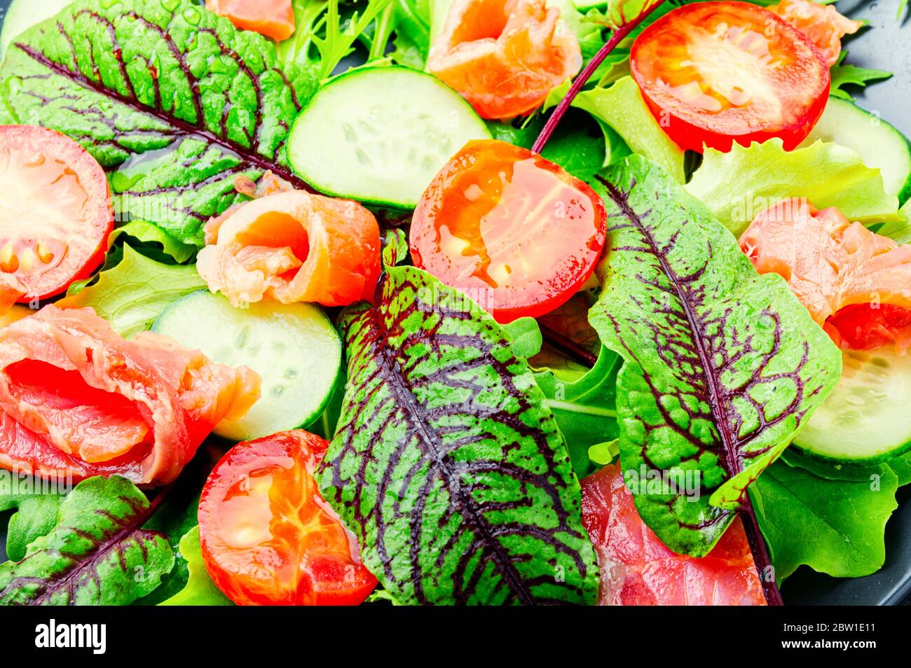 Healthy fish salad with vegetables and lettuce Stock Photo - Alamy