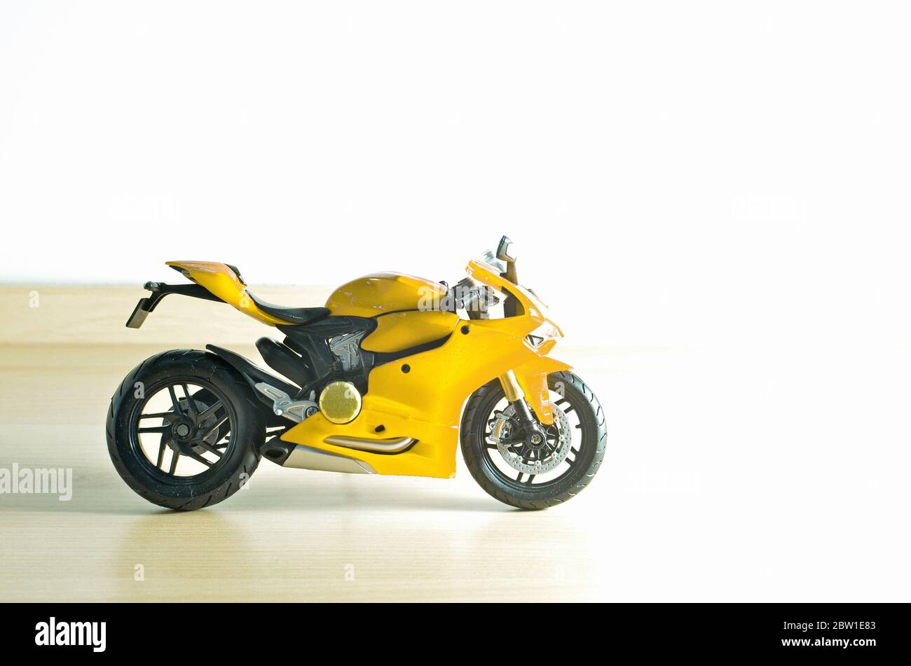 Yellow motorcycle toy with background Stock Photo - Alamy