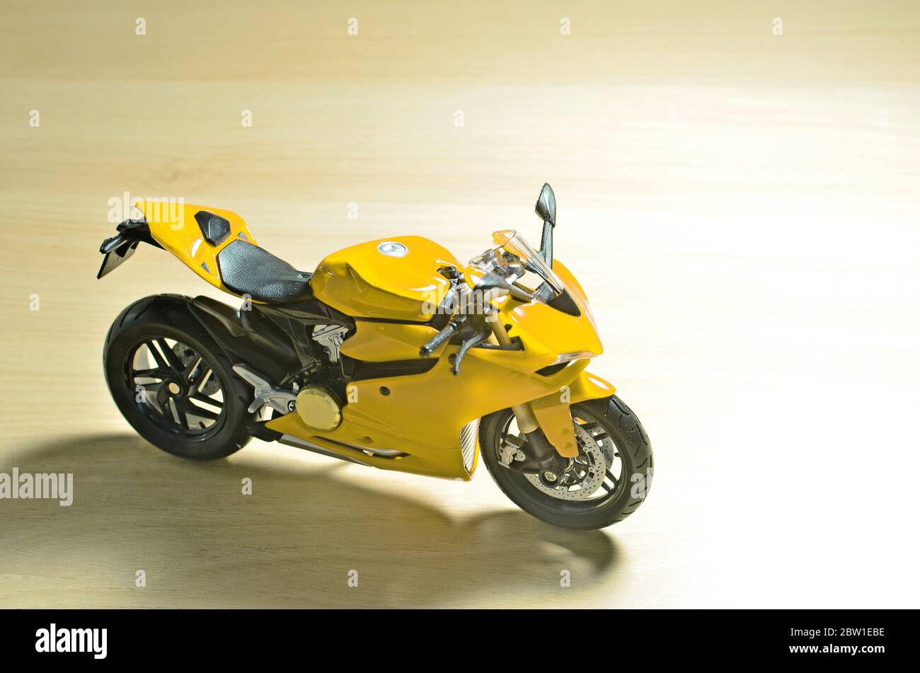 Yellow motorcycle toy with background Stock Photo - Alamy
