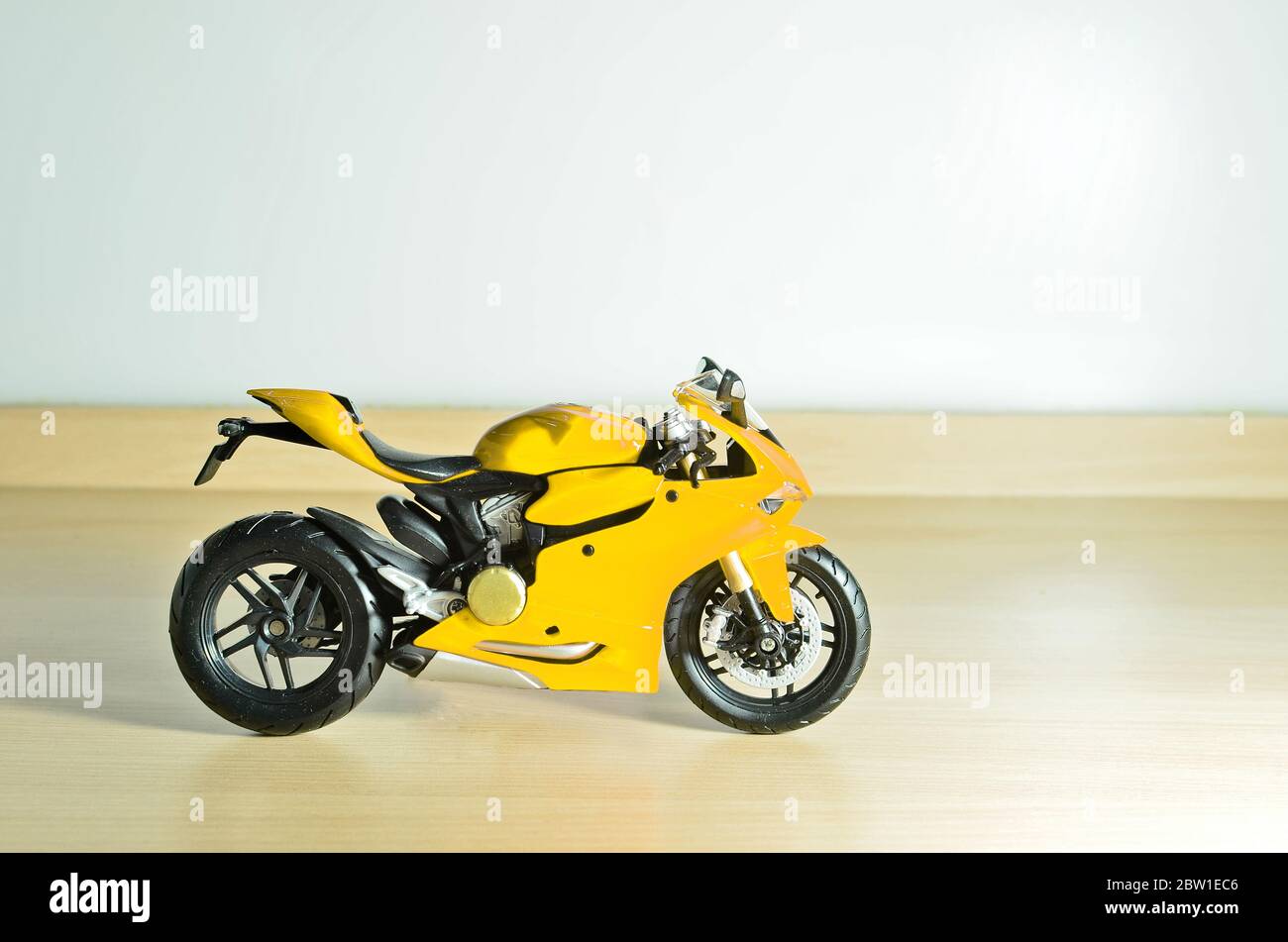 Yellow motorcycle toy with background Stock Photo - Alamy