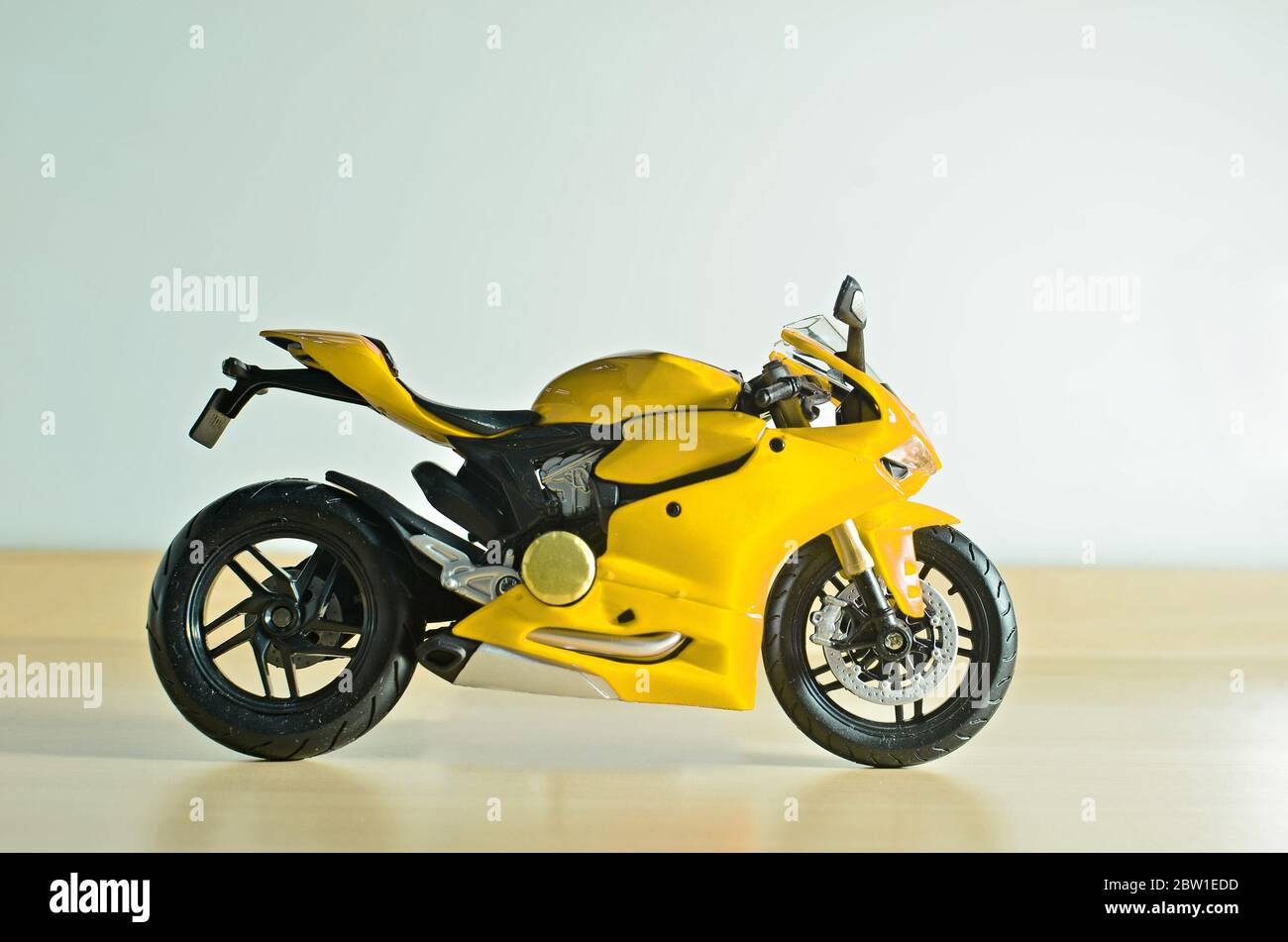 Yellow motorcycle toy with background Stock Photo - Alamy