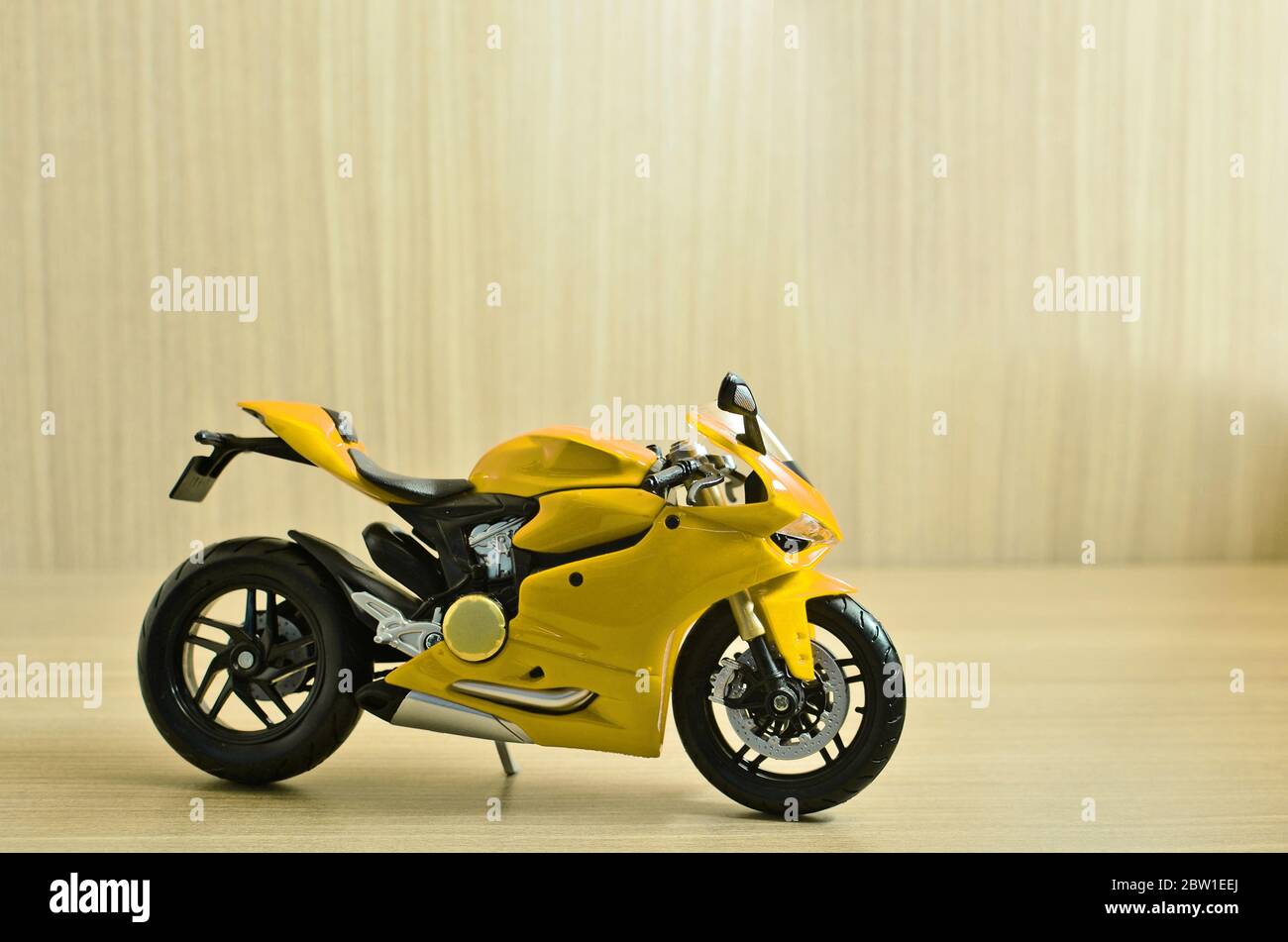 Yellow motorcycle toy with background Stock Photo - Alamy