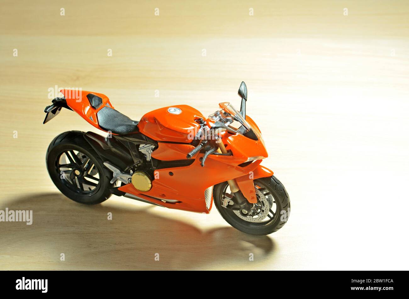 Orange motorcycle toy with background Stock Photo - Alamy