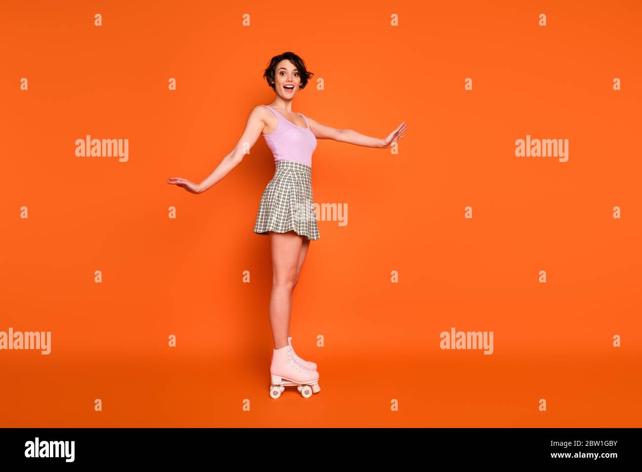 Full length profile side photo of surprised girl ride roller skates ...