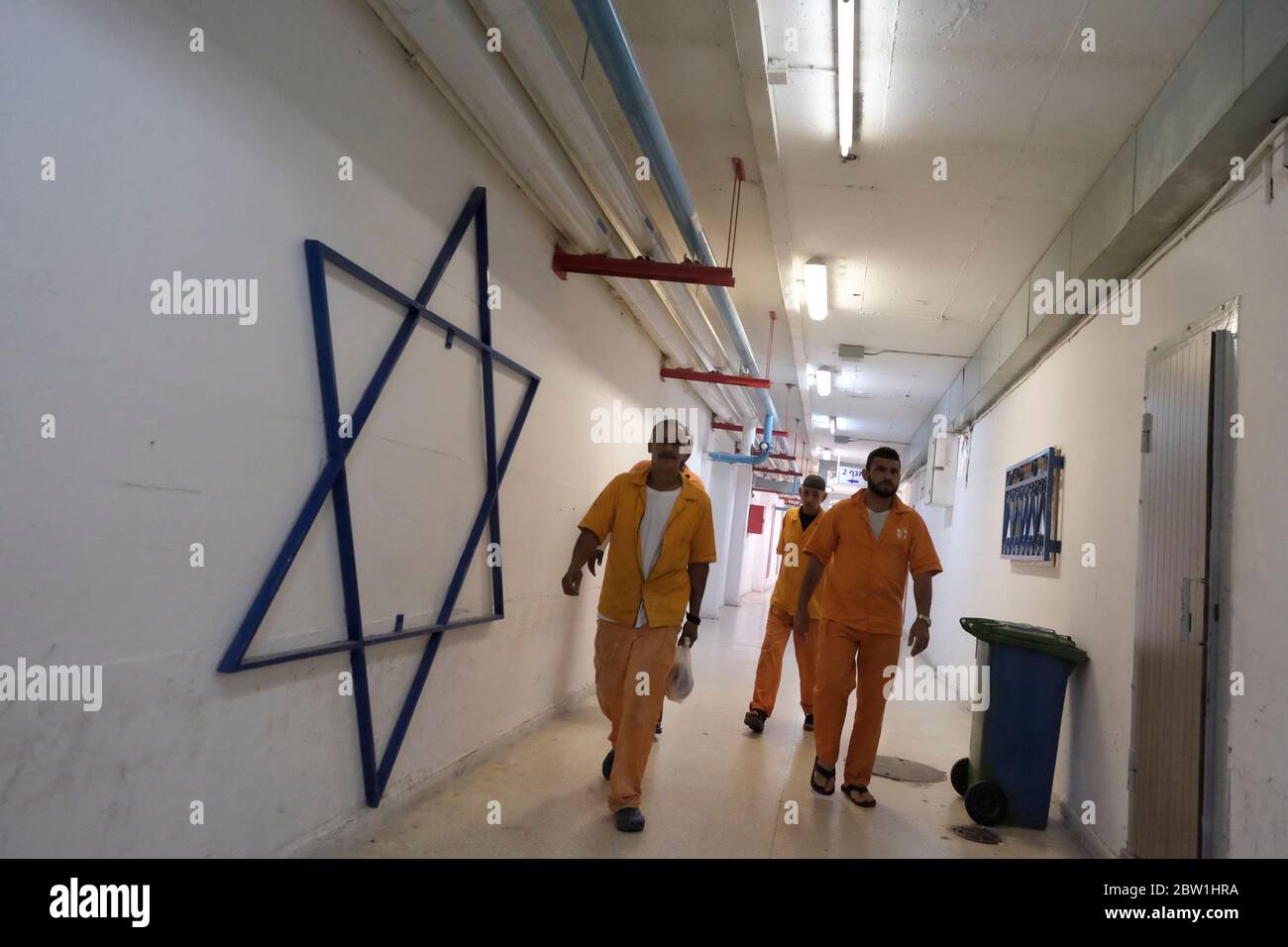 Israeli Arab prisoners walking along a corridor decorated with the ...