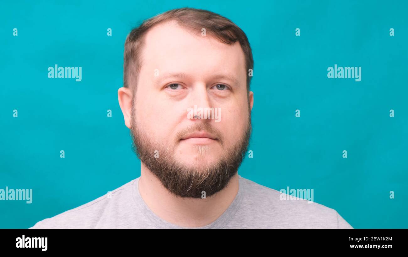 Portrait of a sad bearded man 35 years old on a green screen Stock ...