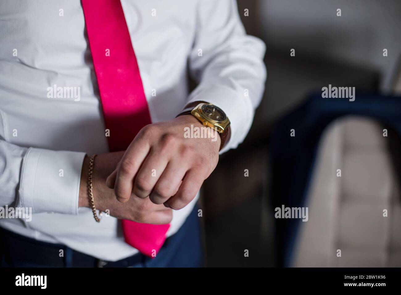 man puts watch on his hand Stock Photo - Alamy