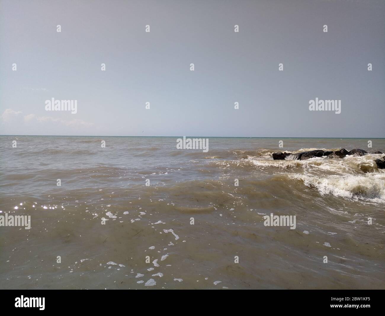 muddy sea water on cloudy day Stock Photo - Alamy