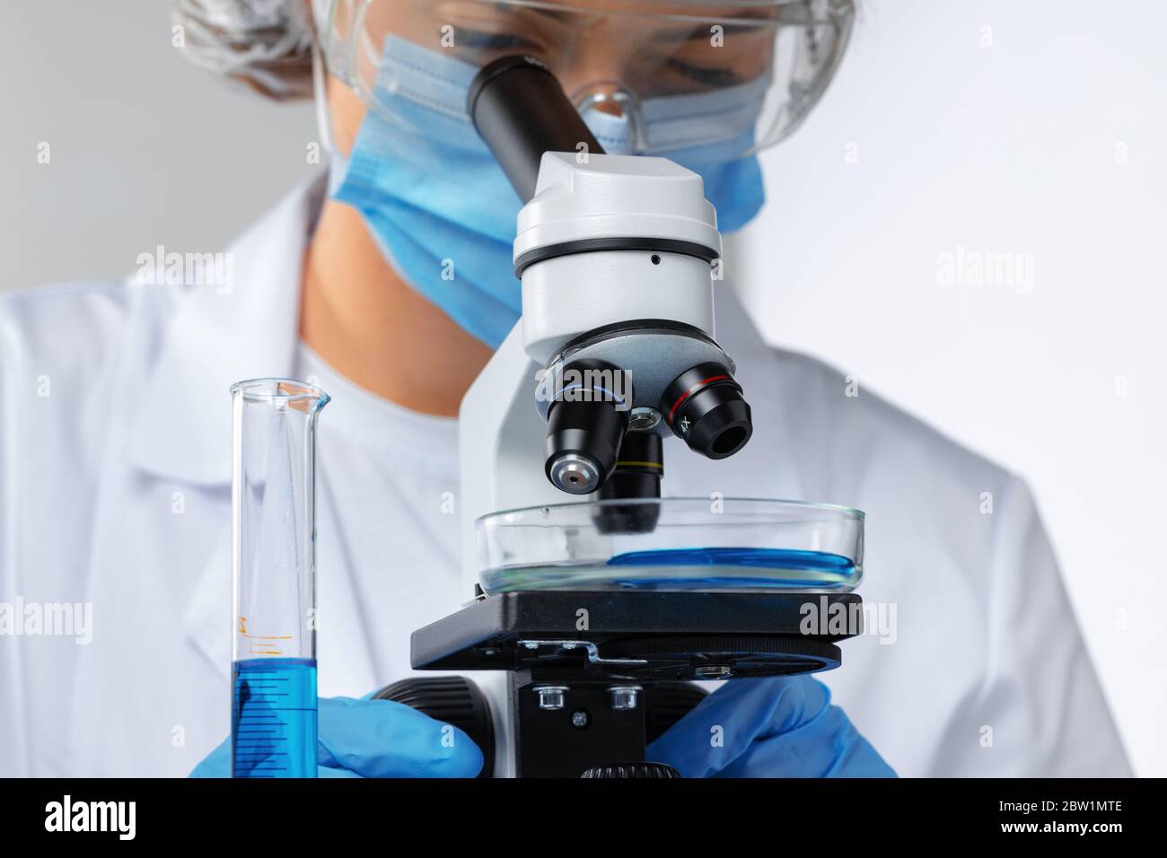 Close up photo of woman scientist working with microscope Stock Photo ...