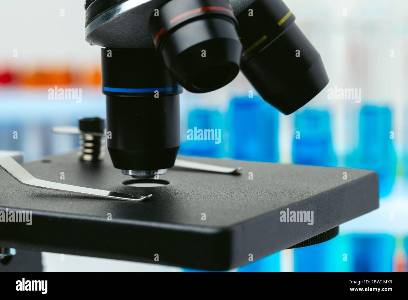 Microscope and test tubes on table in laboratory, close up Stock Photo ...