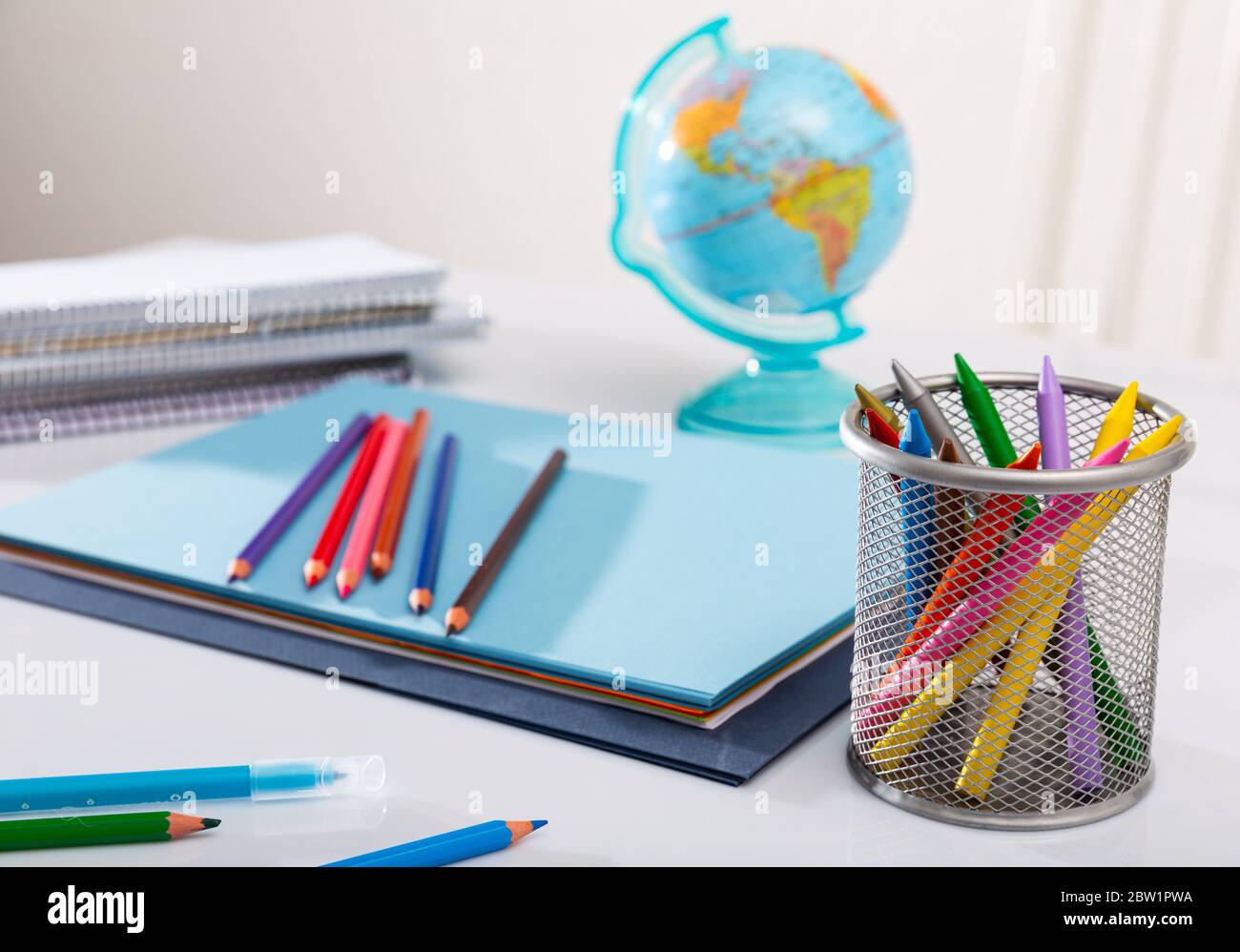 Closeup of colorful school supplies on student desk in home interior ...