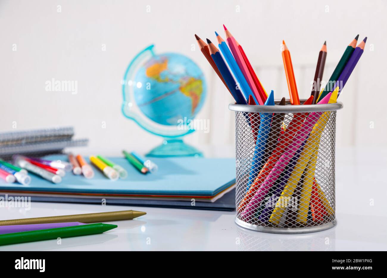 Closeup of colorful school supplies on student desk in home interior ...