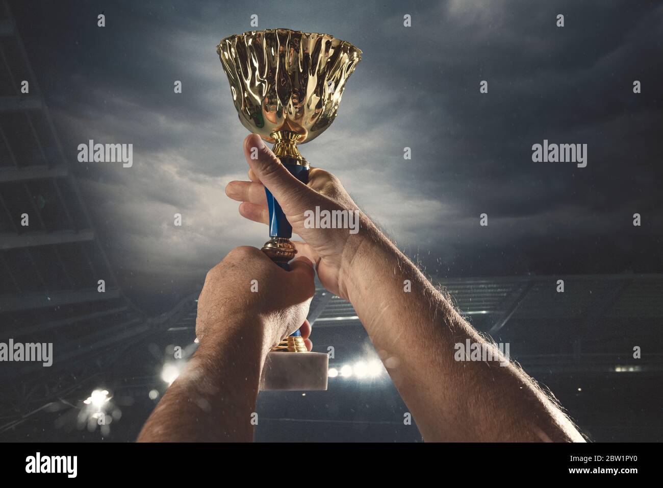 Dream comes true. Award of victory, male hands tightening the golden ...