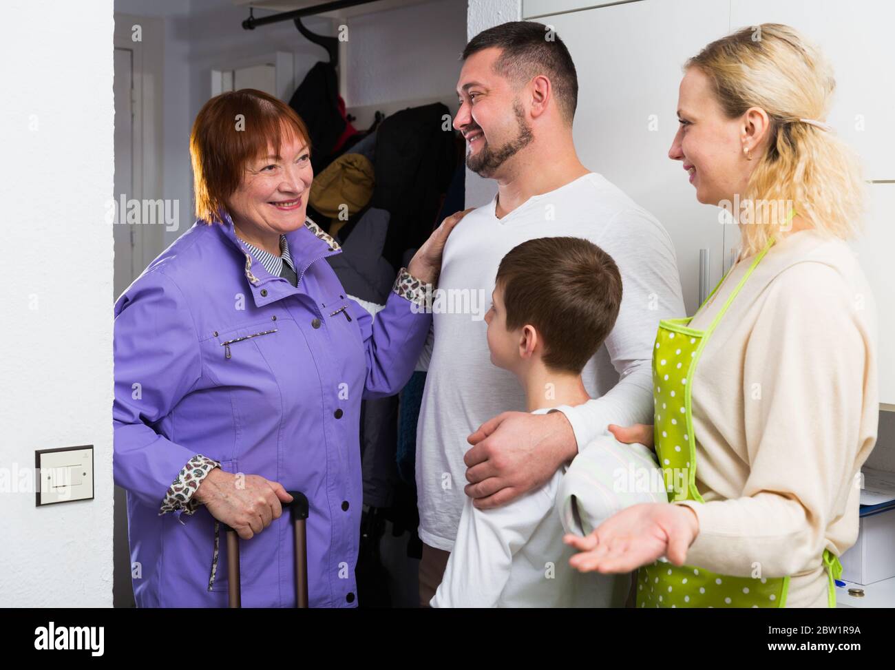 Portrait of happy senior woman visiting family of her son at home Stock ...